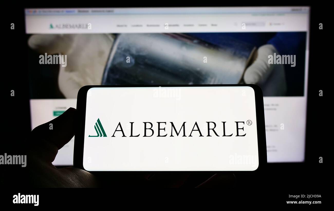 Person holding smartphone with logo of US chemicals company Albemarle ...