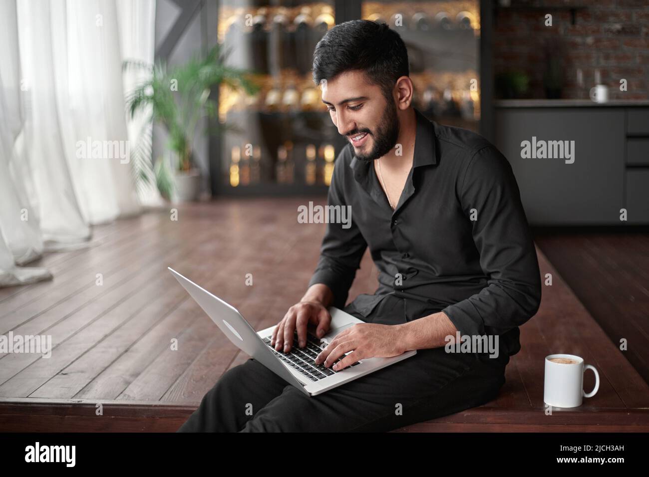 happy business owner using a laptop in his new cafe Stock Photo - Alamy