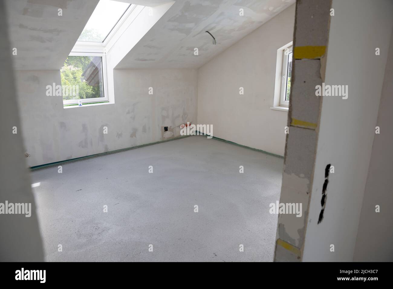 freshly cured concrete screed on construction site in loft in a family ...