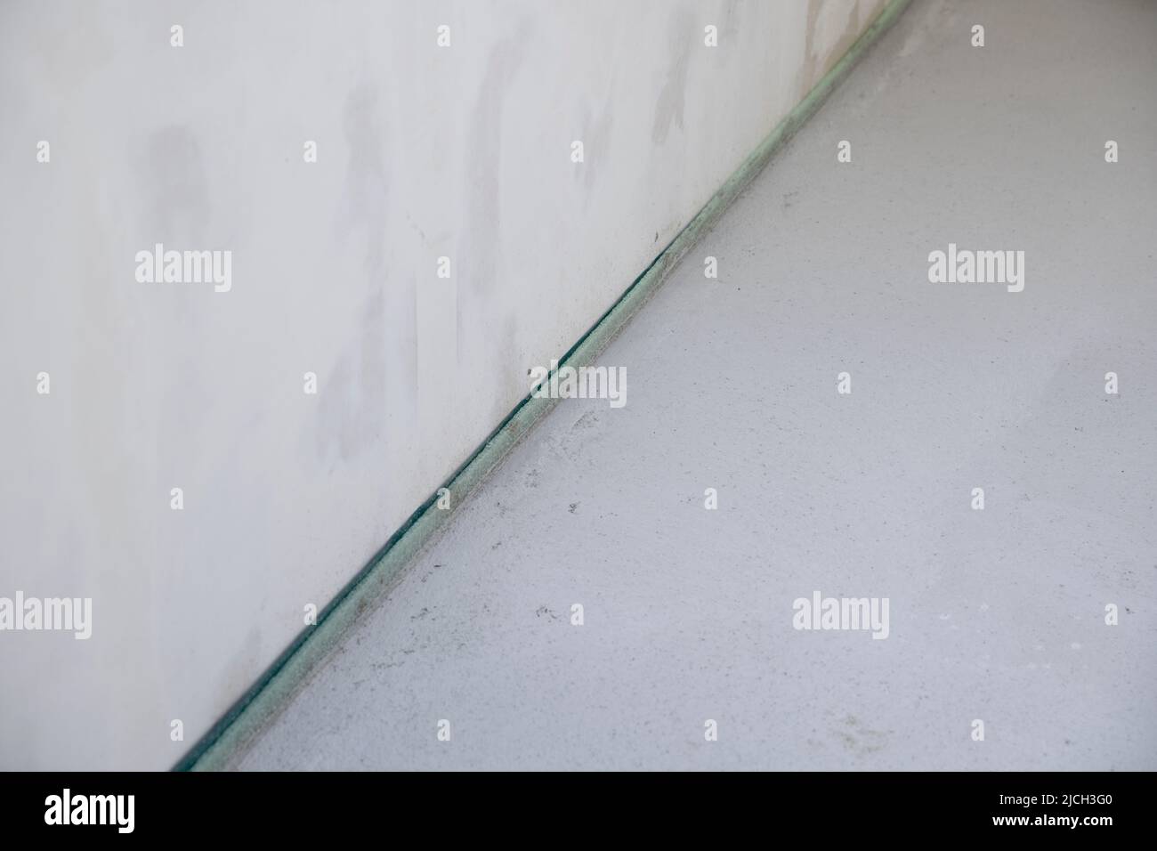 freshly cured concrete screed on construction site in loft in a family ...