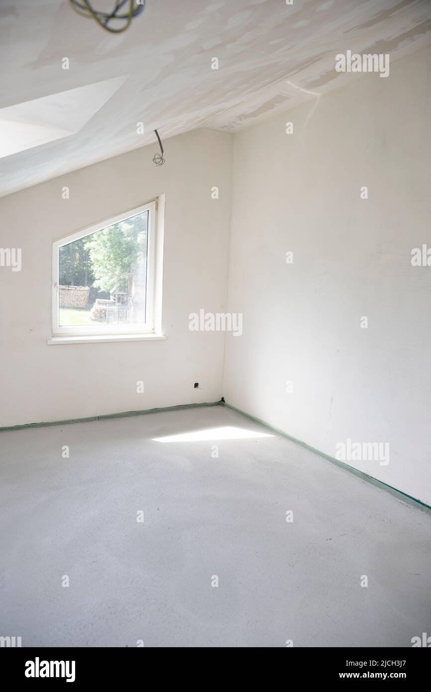 freshly cured concrete screed on construction site in loft in a family ...