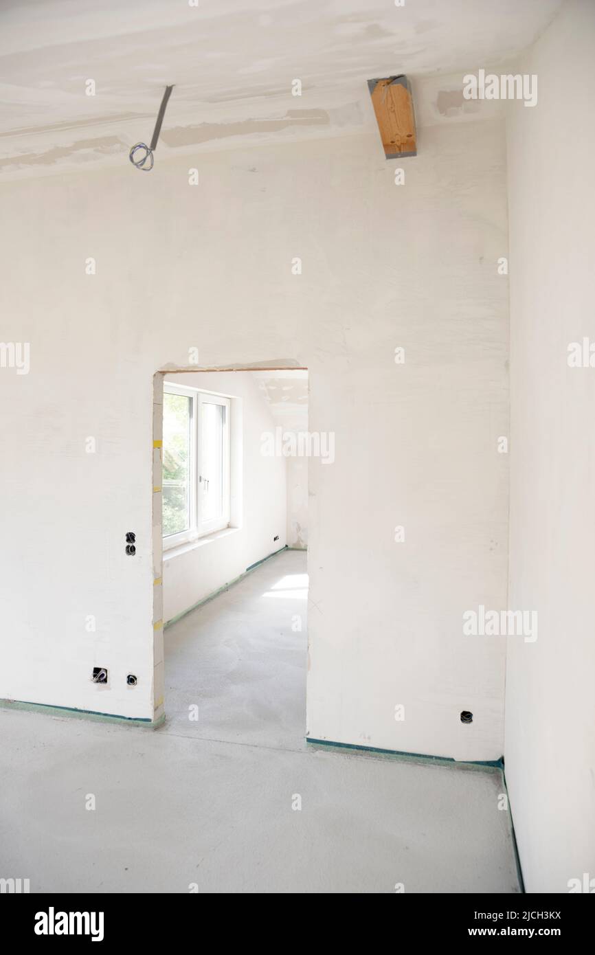 freshly cured concrete screed on construction site in loft in a family ...