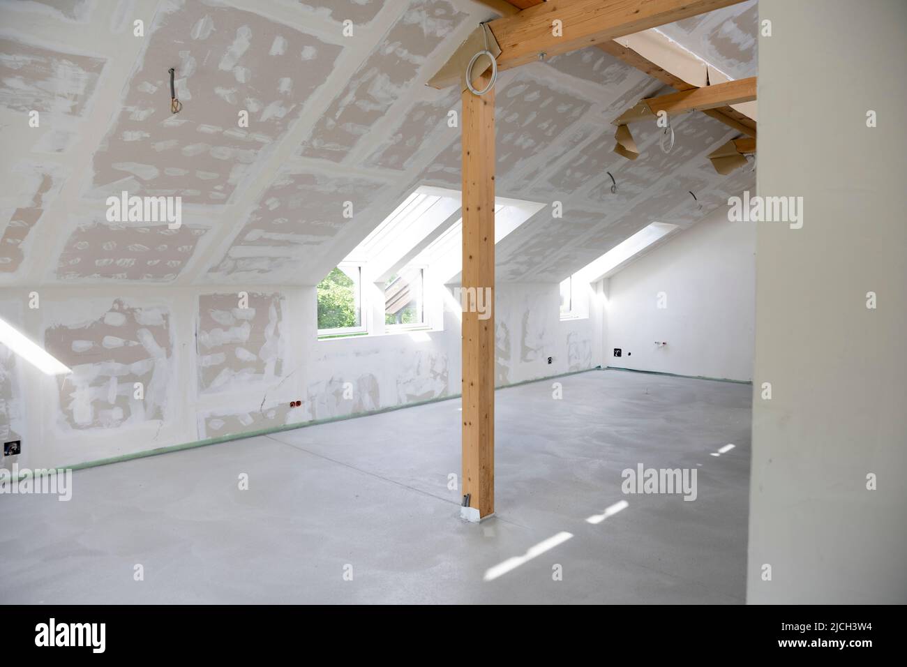 freshly cured concrete screed on construction site in loft in a family ...