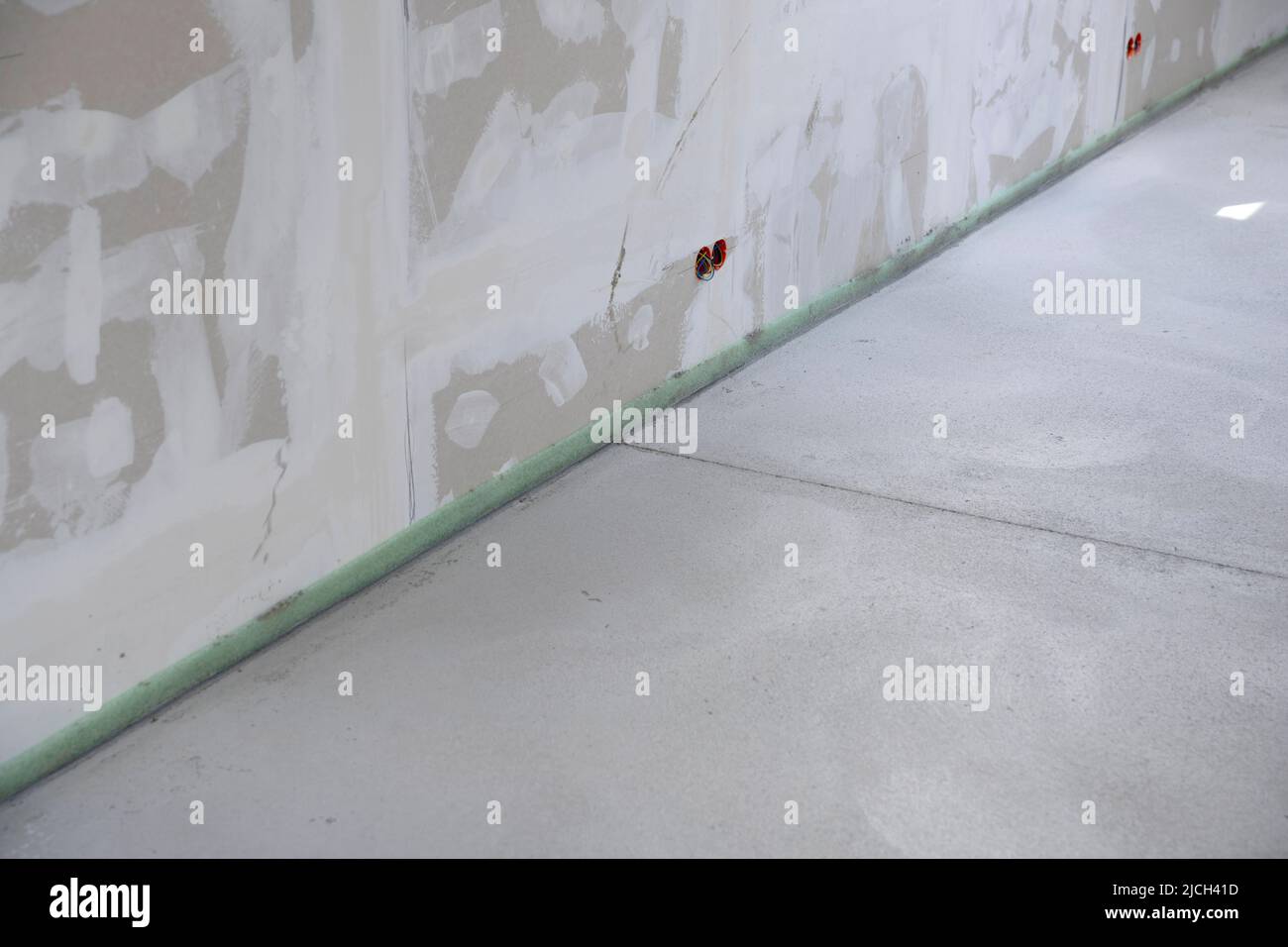 freshly cured concrete screed on construction site in loft in a family ...