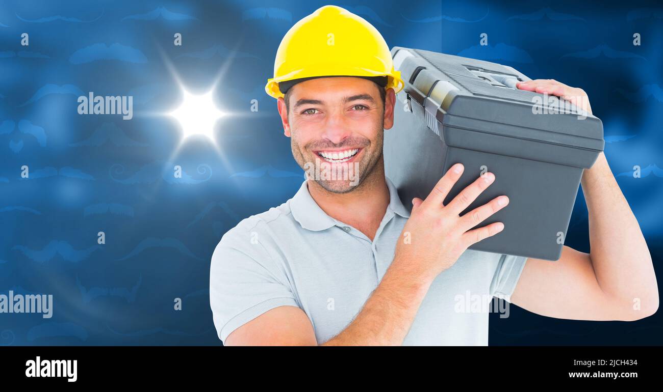 Caucasian male worker carrying a case against spot of light on blue ...
