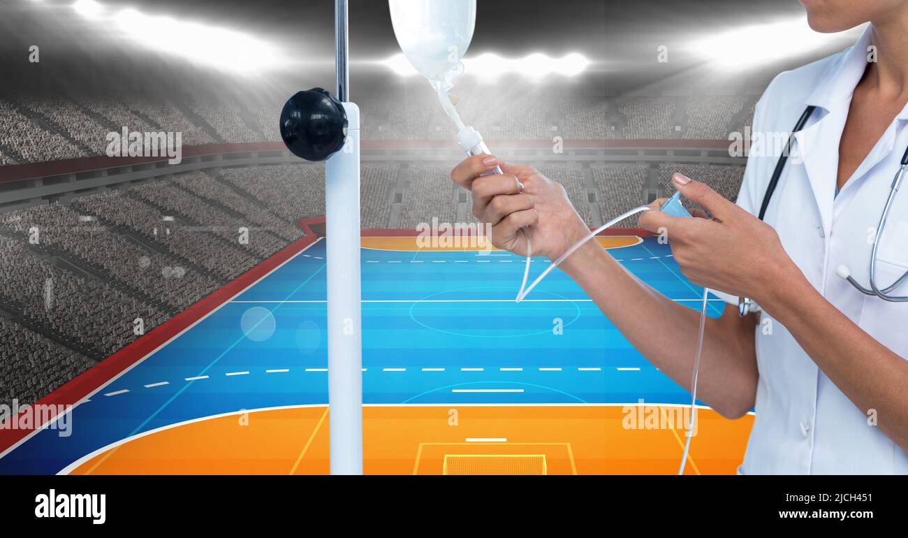 Female health worker regulating the intravenous drip against sports ...