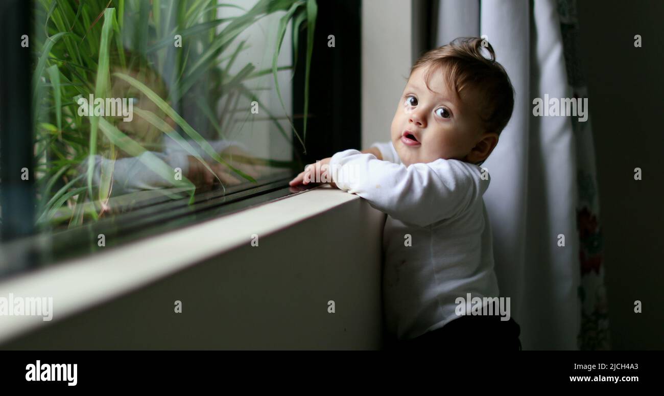 Cute baby boy leaning by window at home. Infant smiling portrait Stock ...