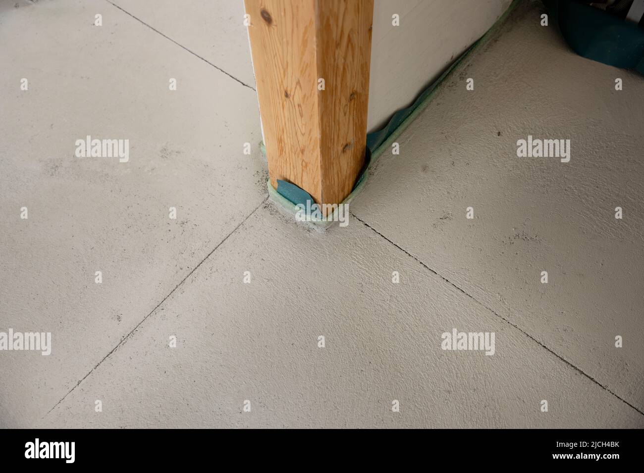 freshly cured concrete screed on construction site in loft in a family ...