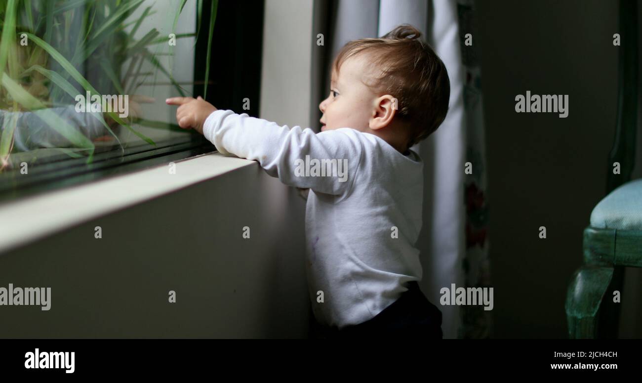 Cute baby boy leaning by window at home. Infant smiling portrait Stock ...
