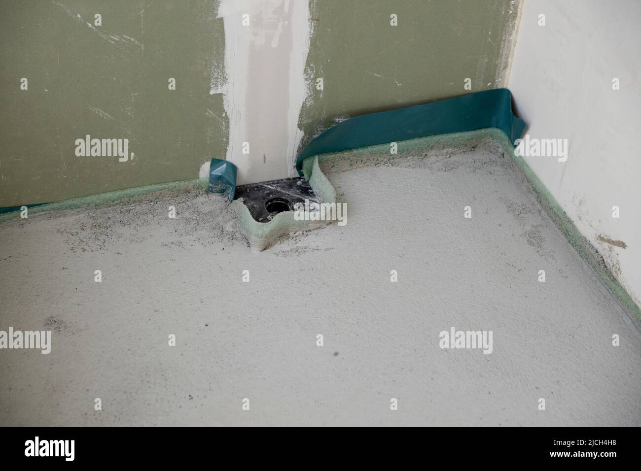 freshly cured concrete screed on construction site in loft in a family ...