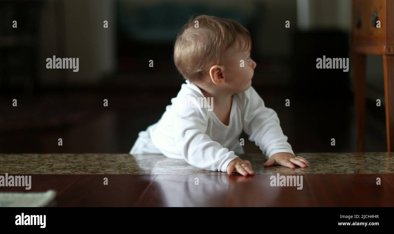 Cute baby learning to climb down home step, infant development Stock ...