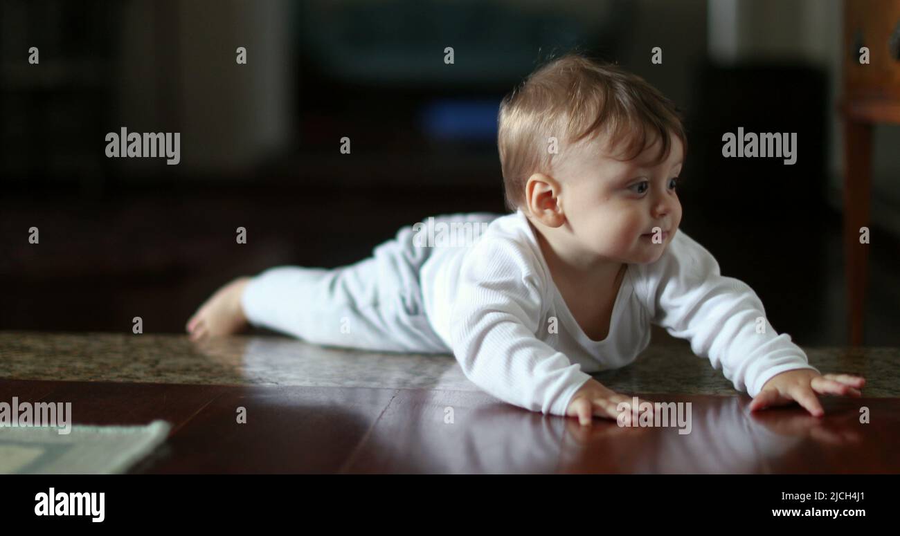 Cute baby learning to climb down home step, infant development Stock ...