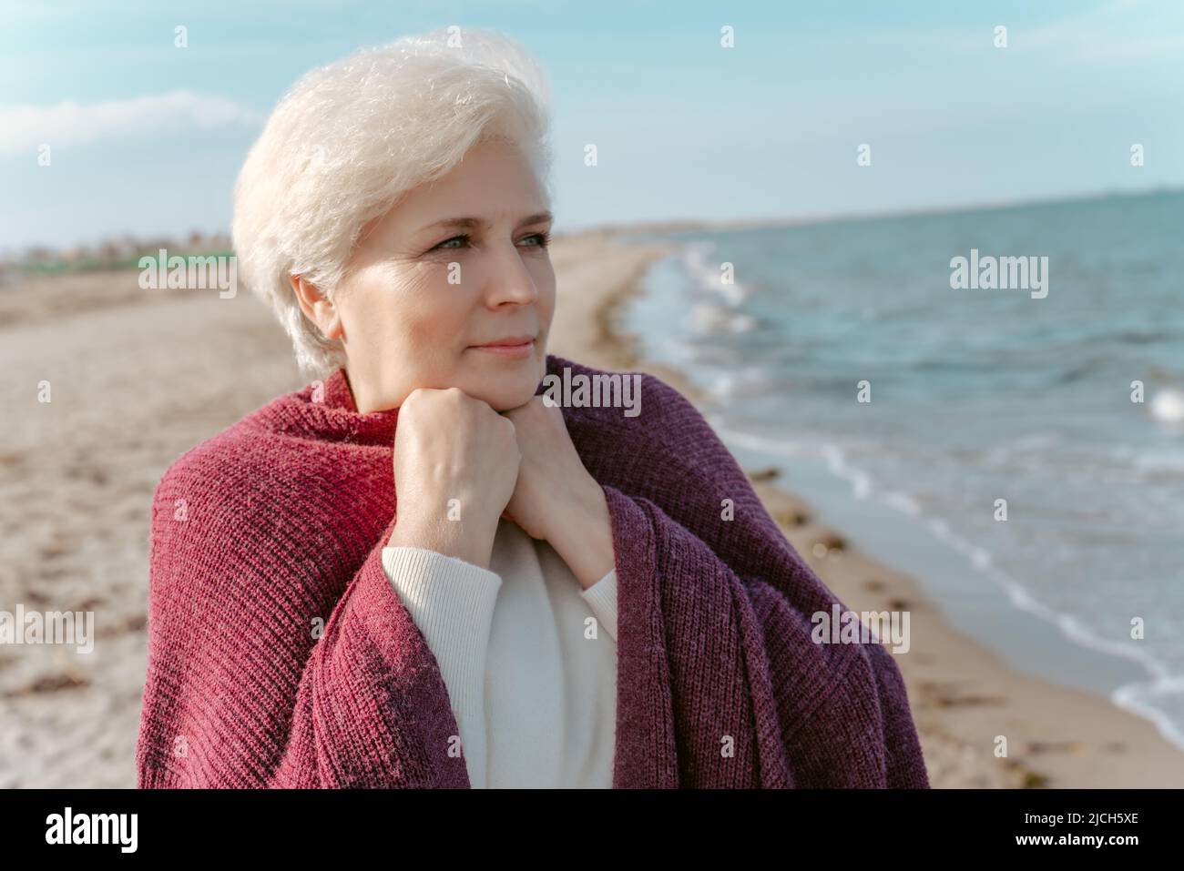 Thoughtful female on the beach by the sea Stock Photo - Alamy