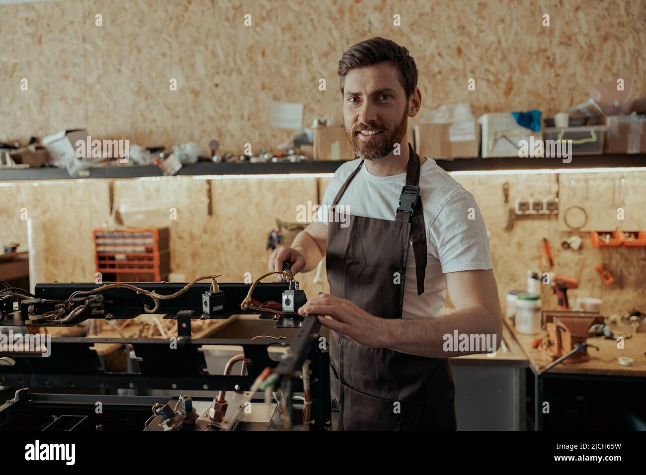 Repair man operating a modern coffee machine Stock Photo - Alamy