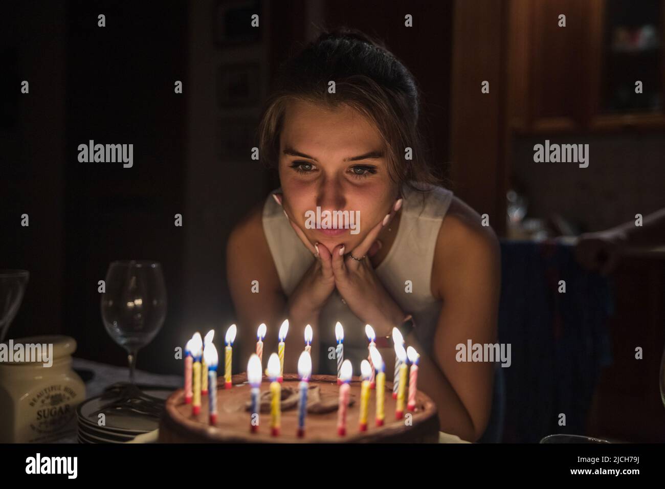 Young girl and cake with burning candles Stock Photo - Alamy