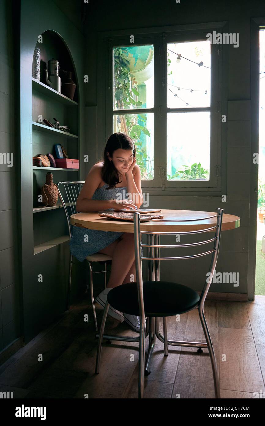 Illustrator woman works with her tablet in a coffee shop Stock Photo ...