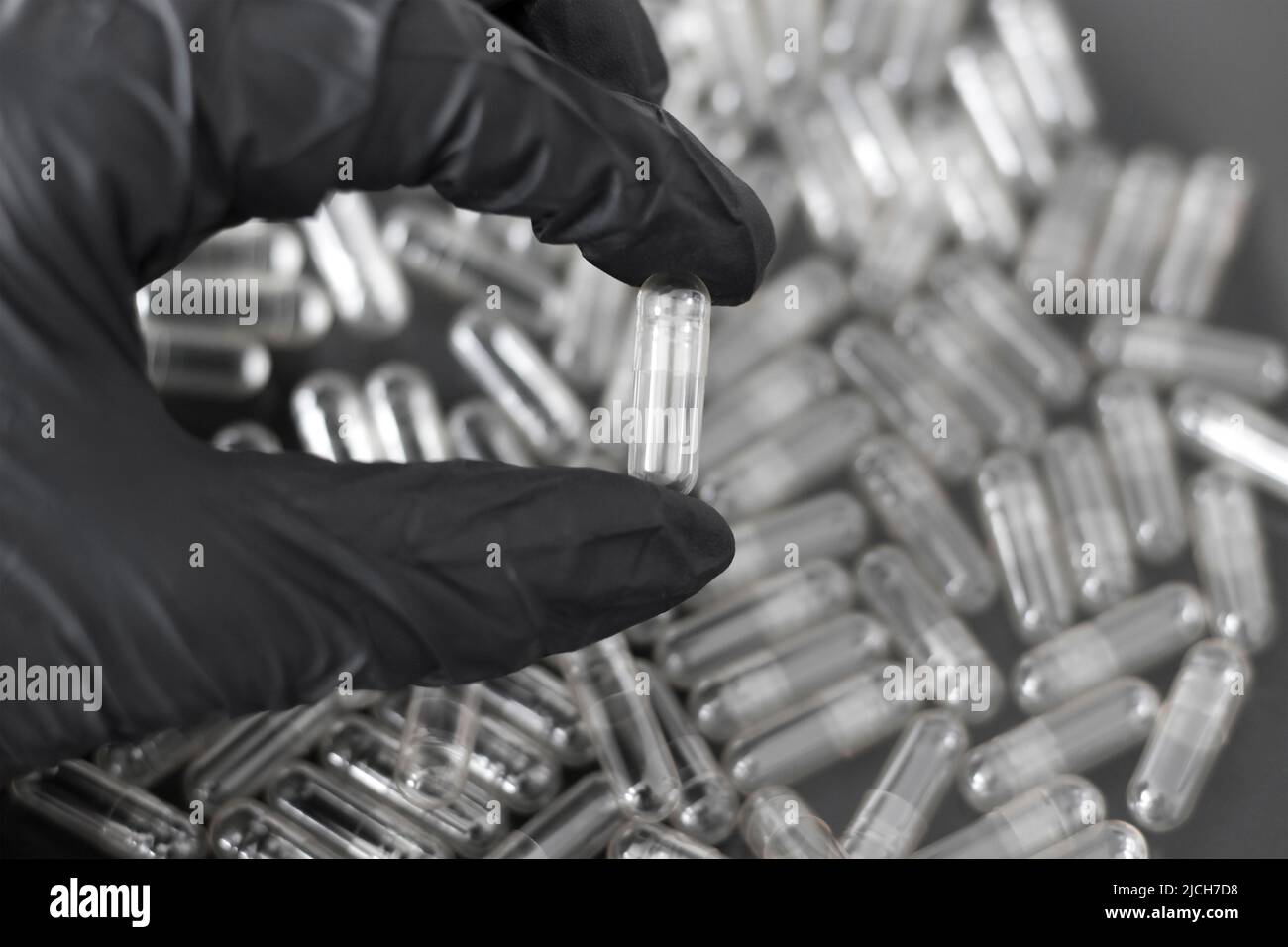 Empty Transparent Capsule in Hand in Black Medical Glove Stock Photo ...