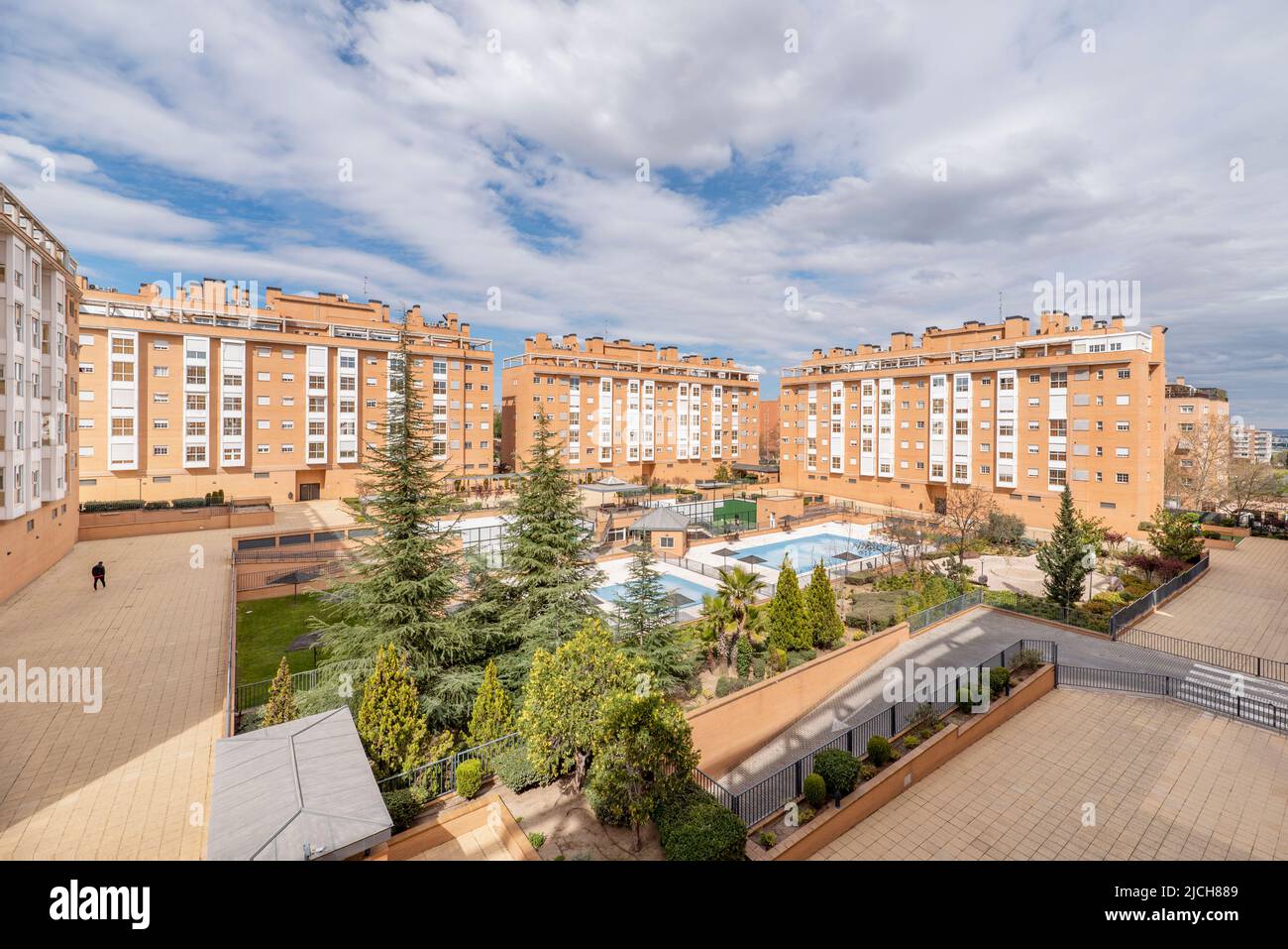 Common areas with swimming pools and gardens in a development of urban ...