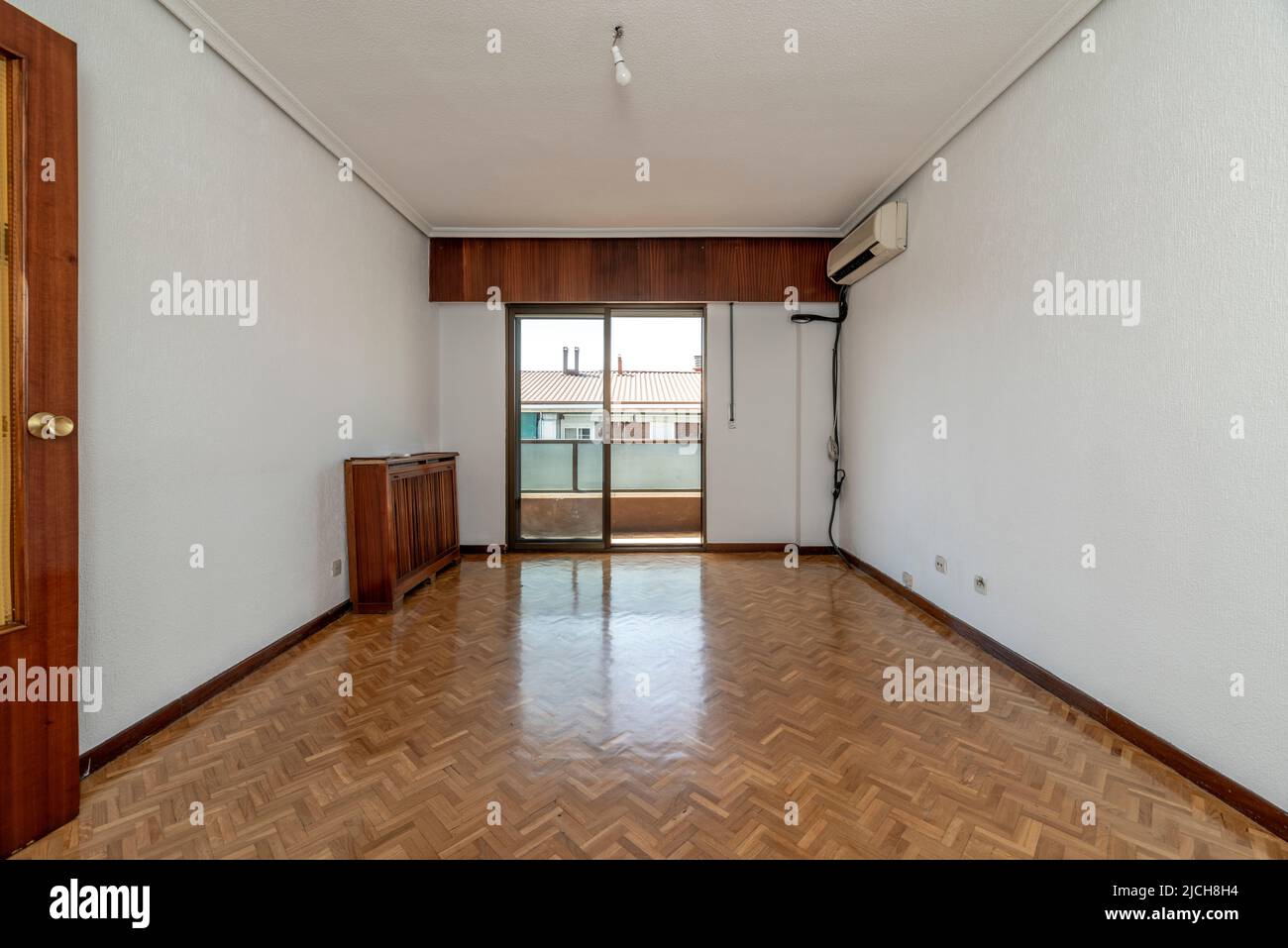 Empty living room with exit to terrace with dark aluminum sliding doors ...