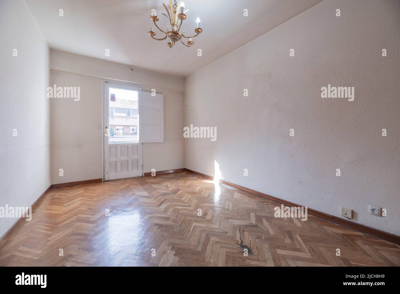 Empty living room with exit to terrace with white wooden door in two ...