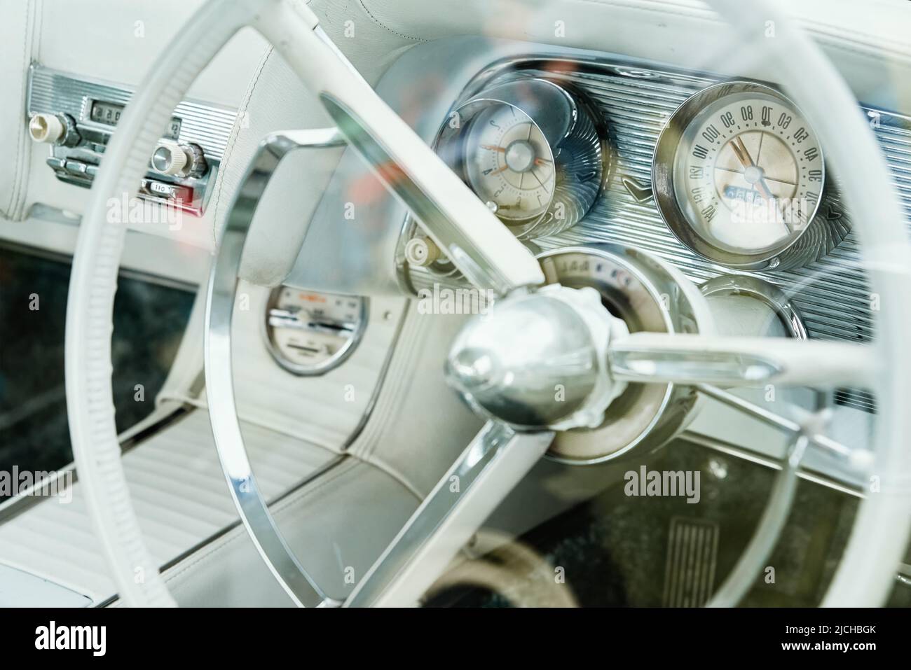 Retro car bright interior, dashboard and steering wheel with controls ...