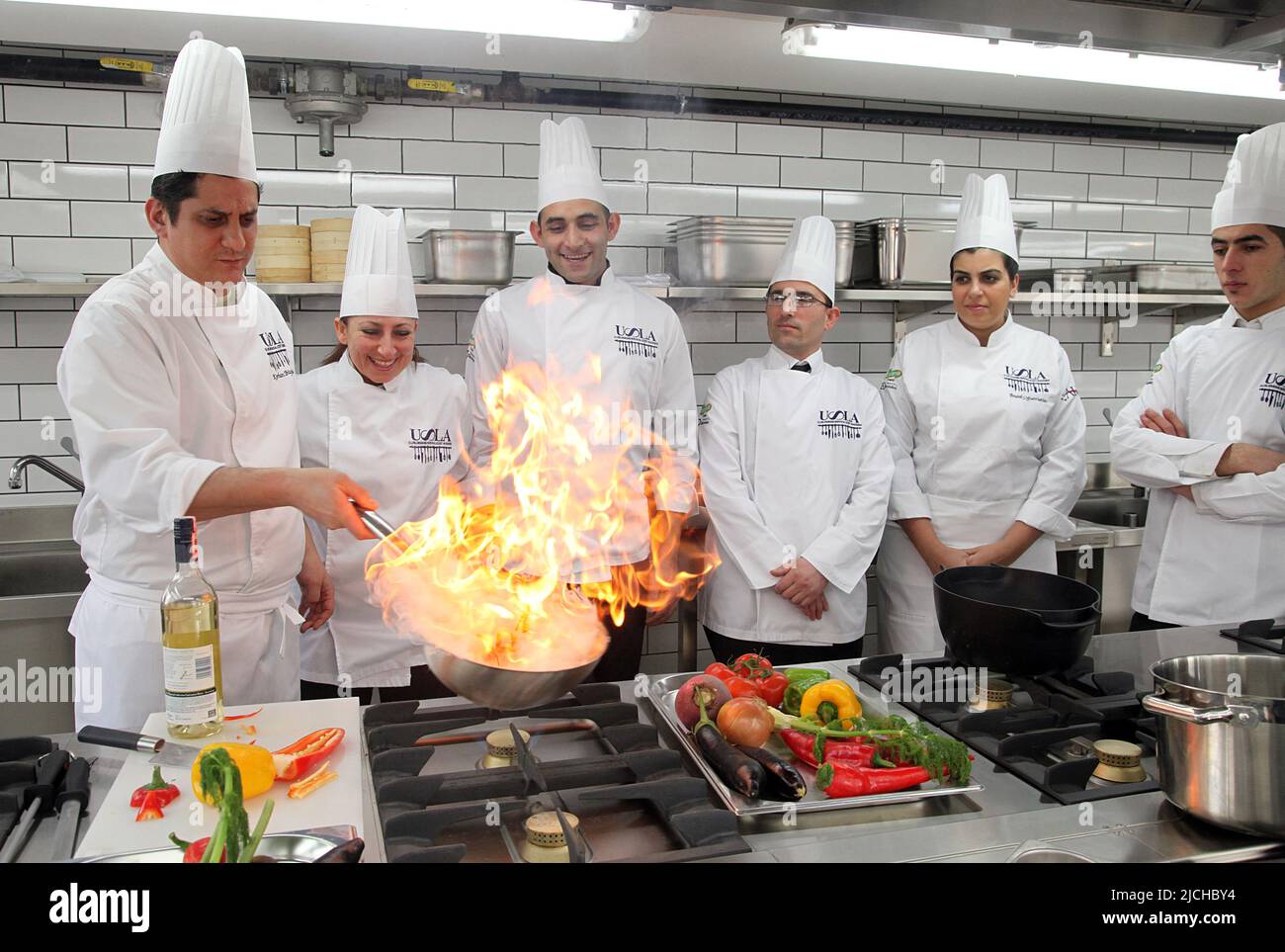 ISTANBUL, TURKEY - JANUARY 2: A chef giving cooking lessons to students ...