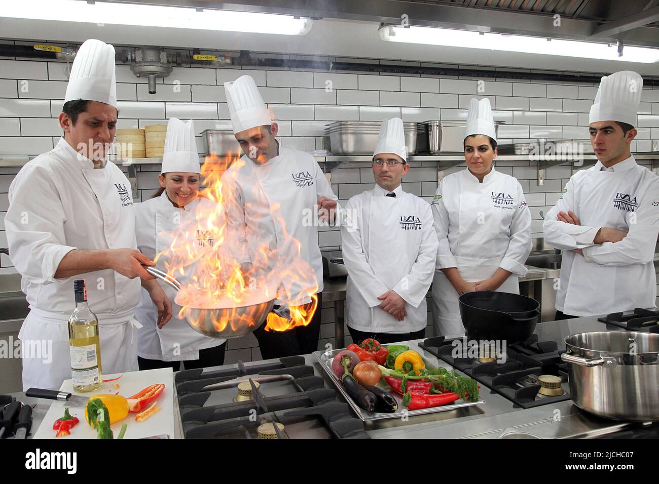 ISTANBUL, TURKEY - JANUARY 2: A chef giving cooking lessons to students ...