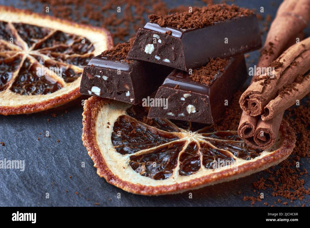 Dark chocolate with crushed almonds, cocoa powder, dried orange slices ...