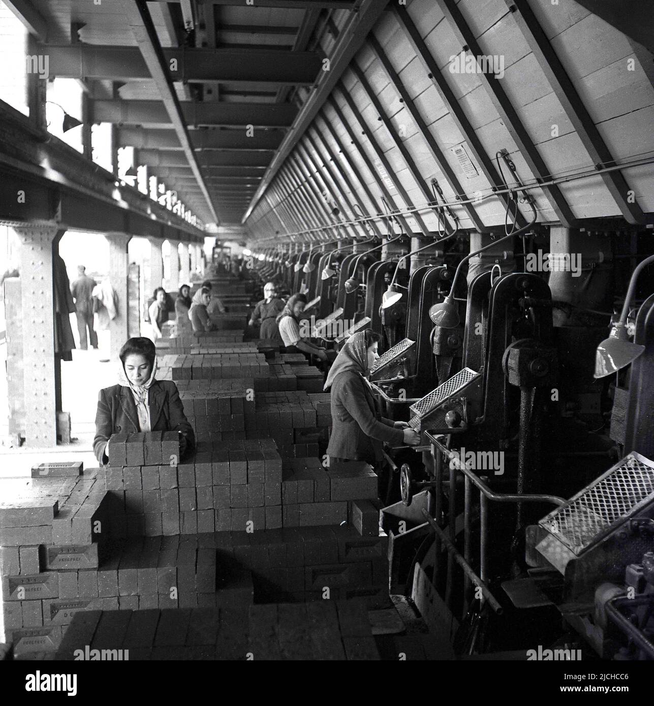 1950s, historical, a long line of women working, finishing bricks, at ...