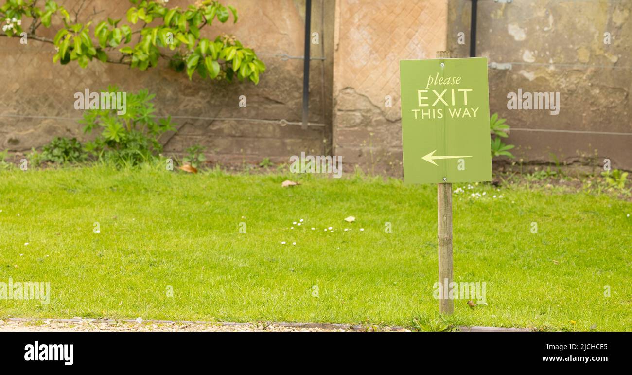 green exit sign on a garden lawn Stock Photo - Alamy