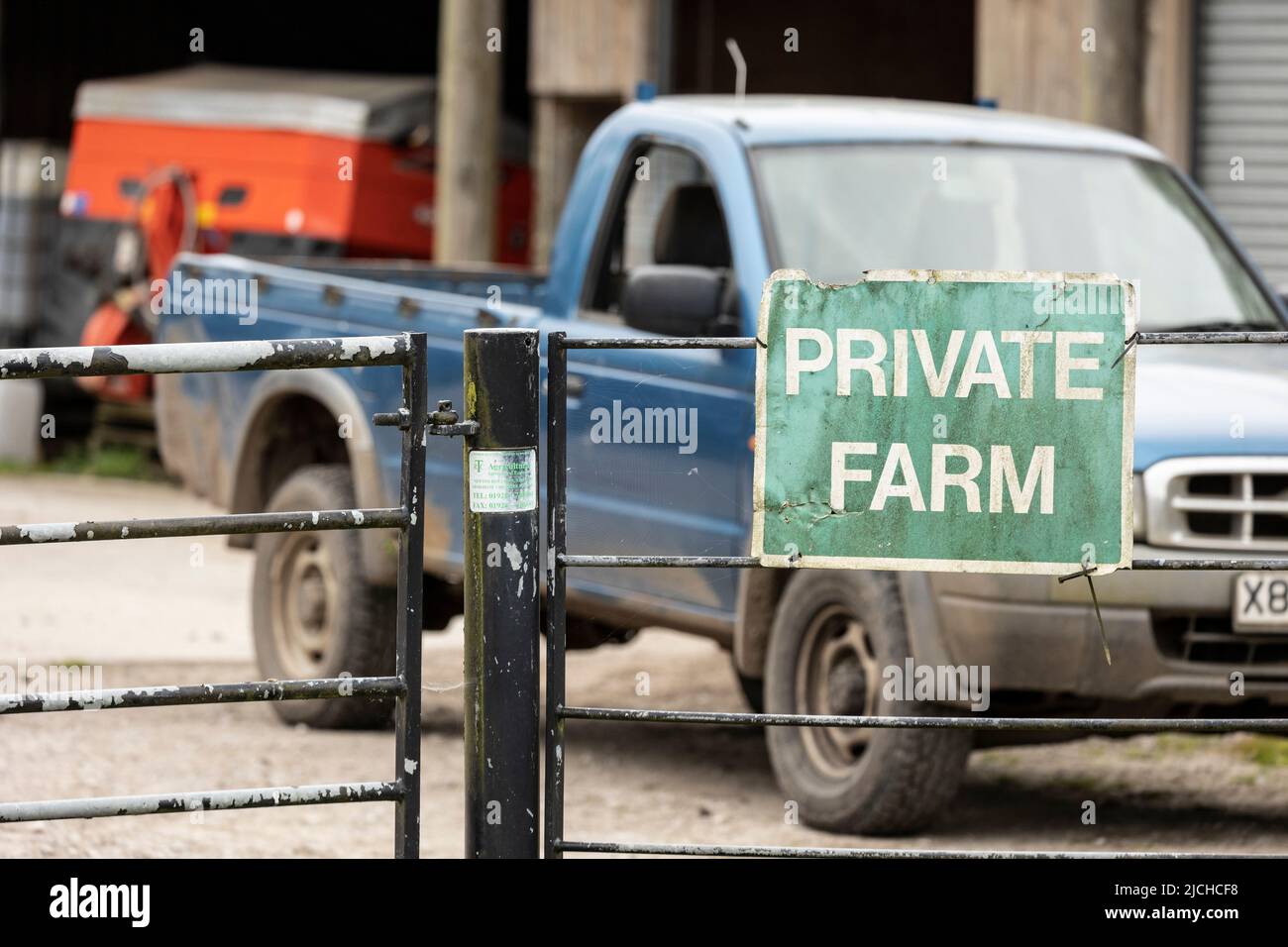 private farm sign white lettering on green background with farm vehicle ...