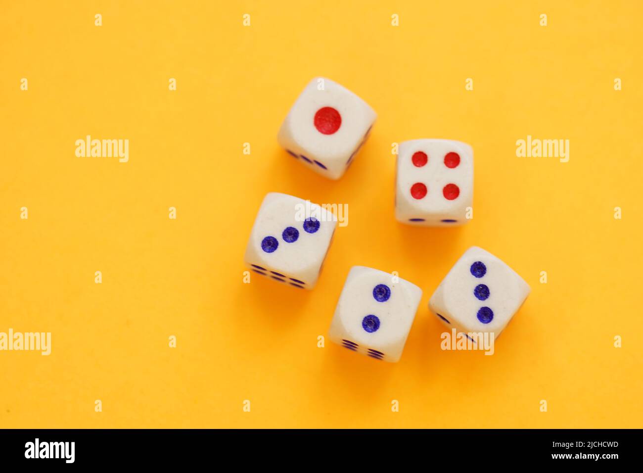 Five dice with different numbers on a orange sunny table Stock Photo ...