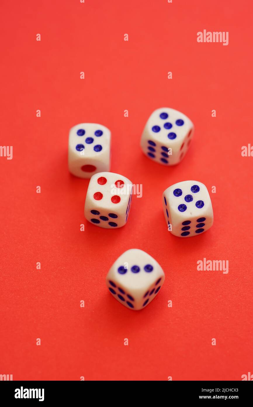 Five dice with different numbers on a red table Stock Photo - Alamy