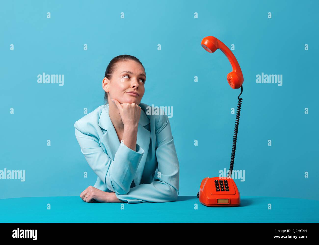 Woman talking over the phone over a blue background, concept, smiling ...