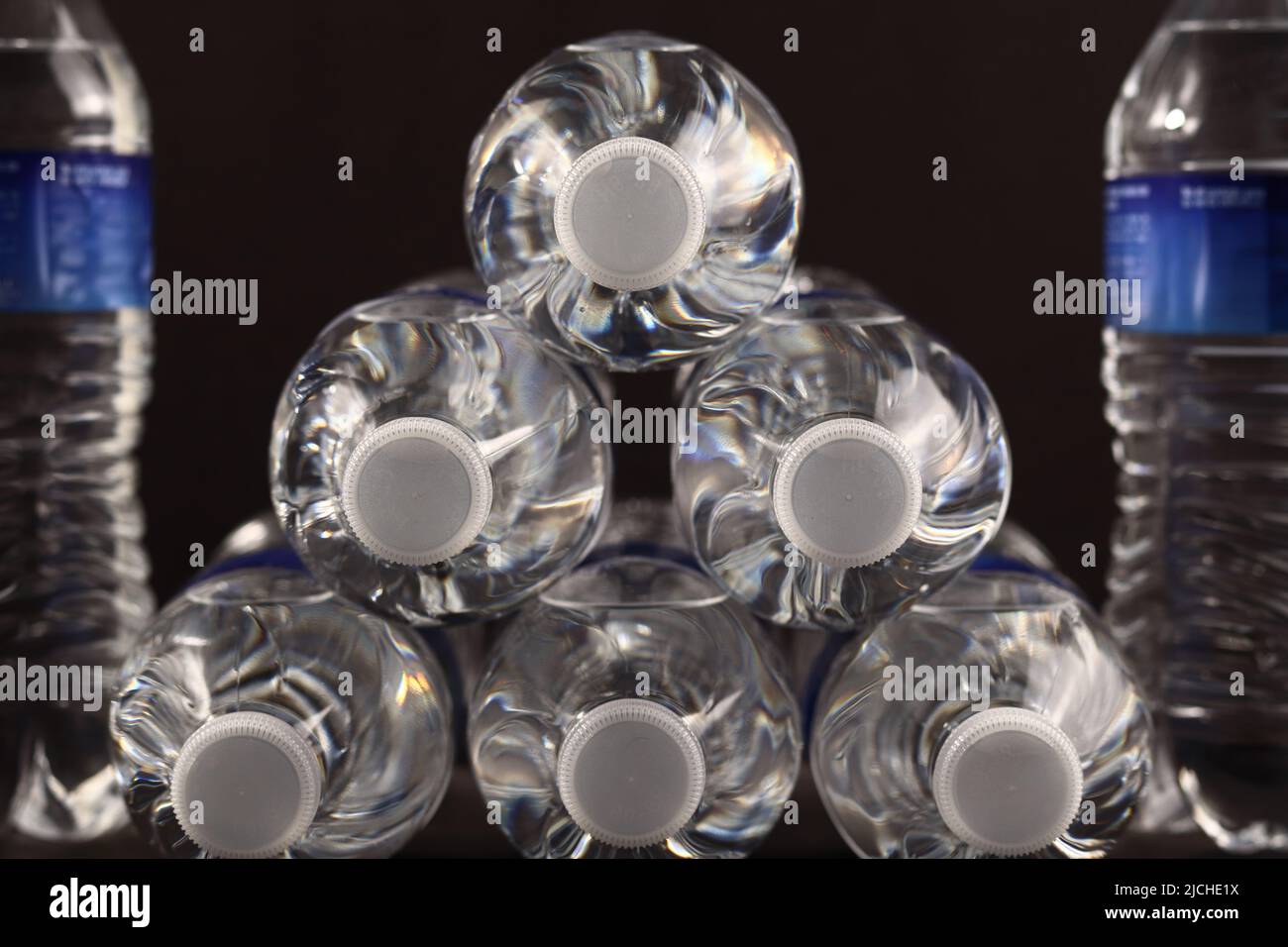 Small water bottles placed in perspective view, and on a black ...