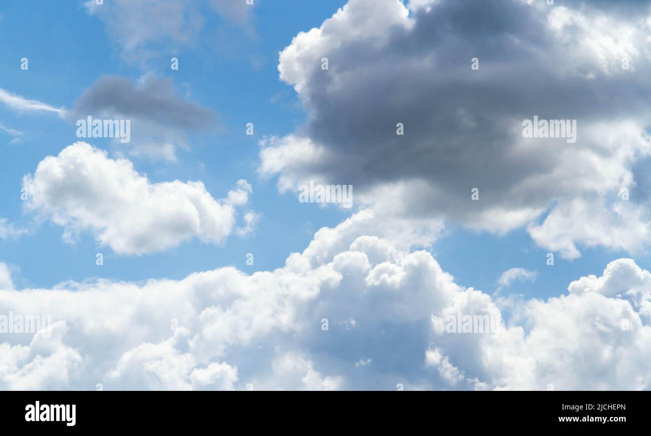 Summer sky. Cumulus clouds on a blue background. Partly cloudy. Dark ...