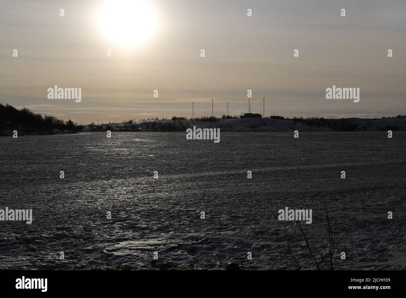 Sunset over icy terrain covered by snow; start of the polar night in ...