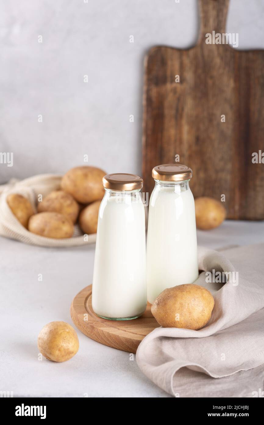 Vegan plant based milk in two glass bottles. Alternative potato milk ...