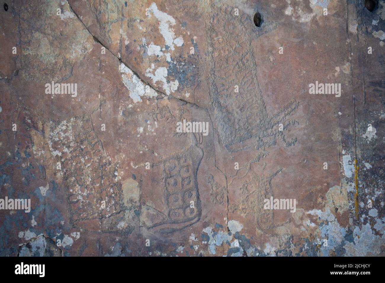 Drawn figures on the stone wall. Rock painting in mountain of Altai ...