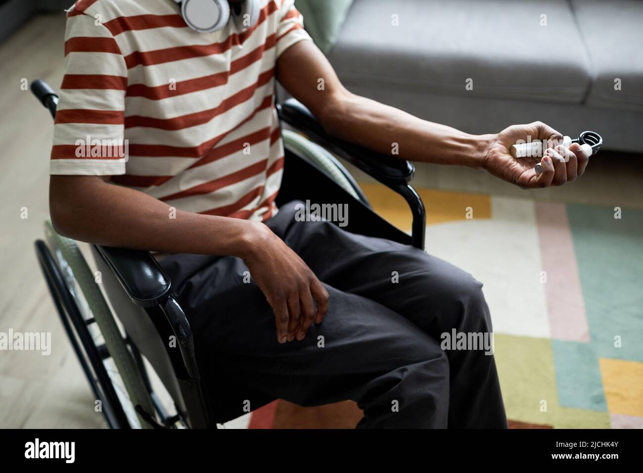 Closeup of man with disability exercising hand and arm muscles by using ...