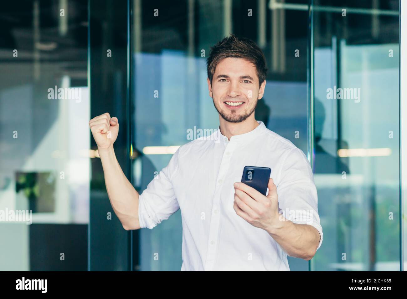 Portrait of a successful businessman man looks at the camera and smiles ...