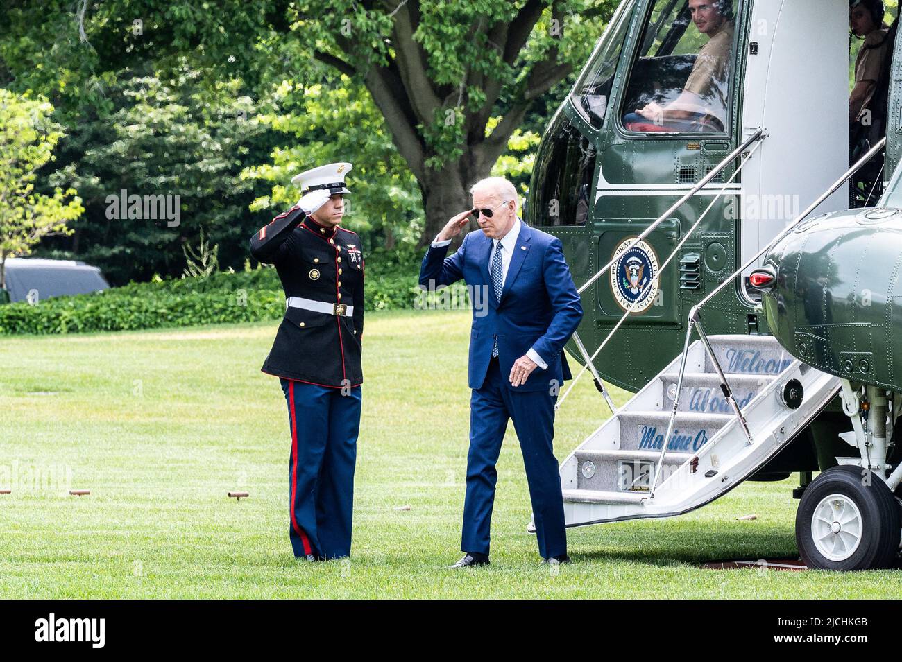 President Joe Biden saluting the Marine aftter returning to the White ...