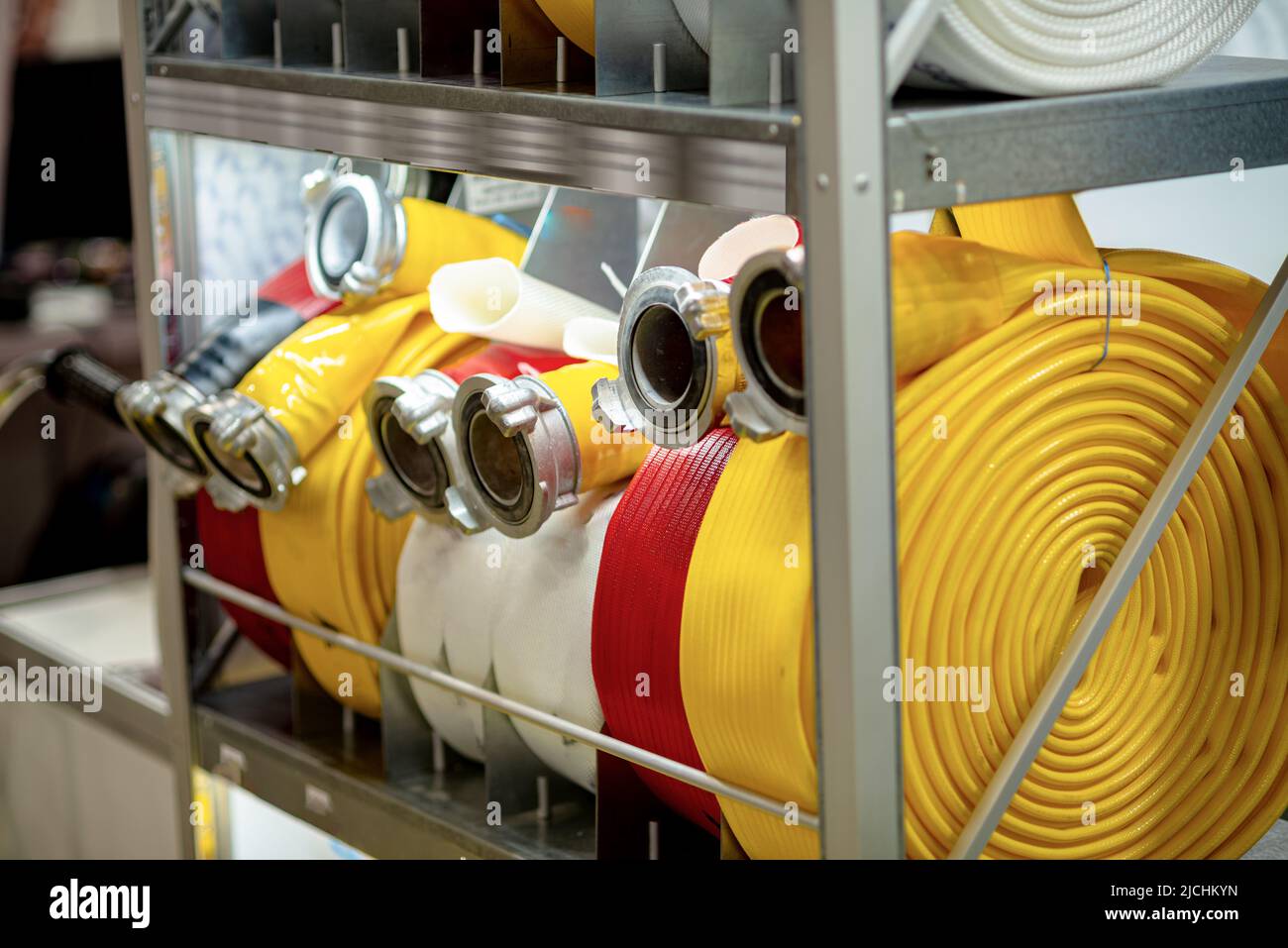 Roll of fire hoses of different colors Stock Photo - Alamy