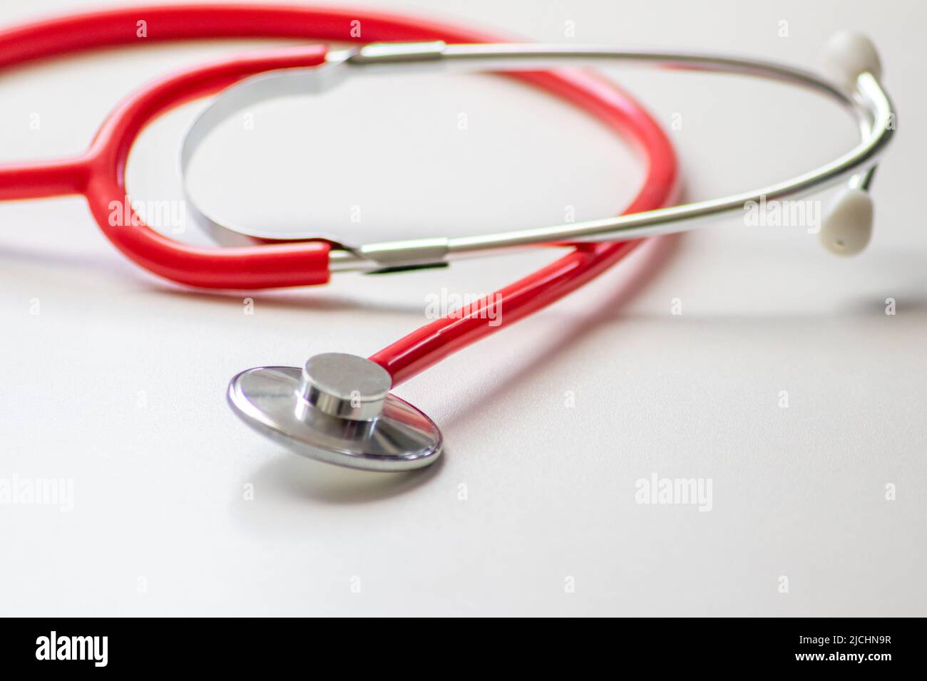 Red stethoscope in doctors office for professional cardio checkup and ...