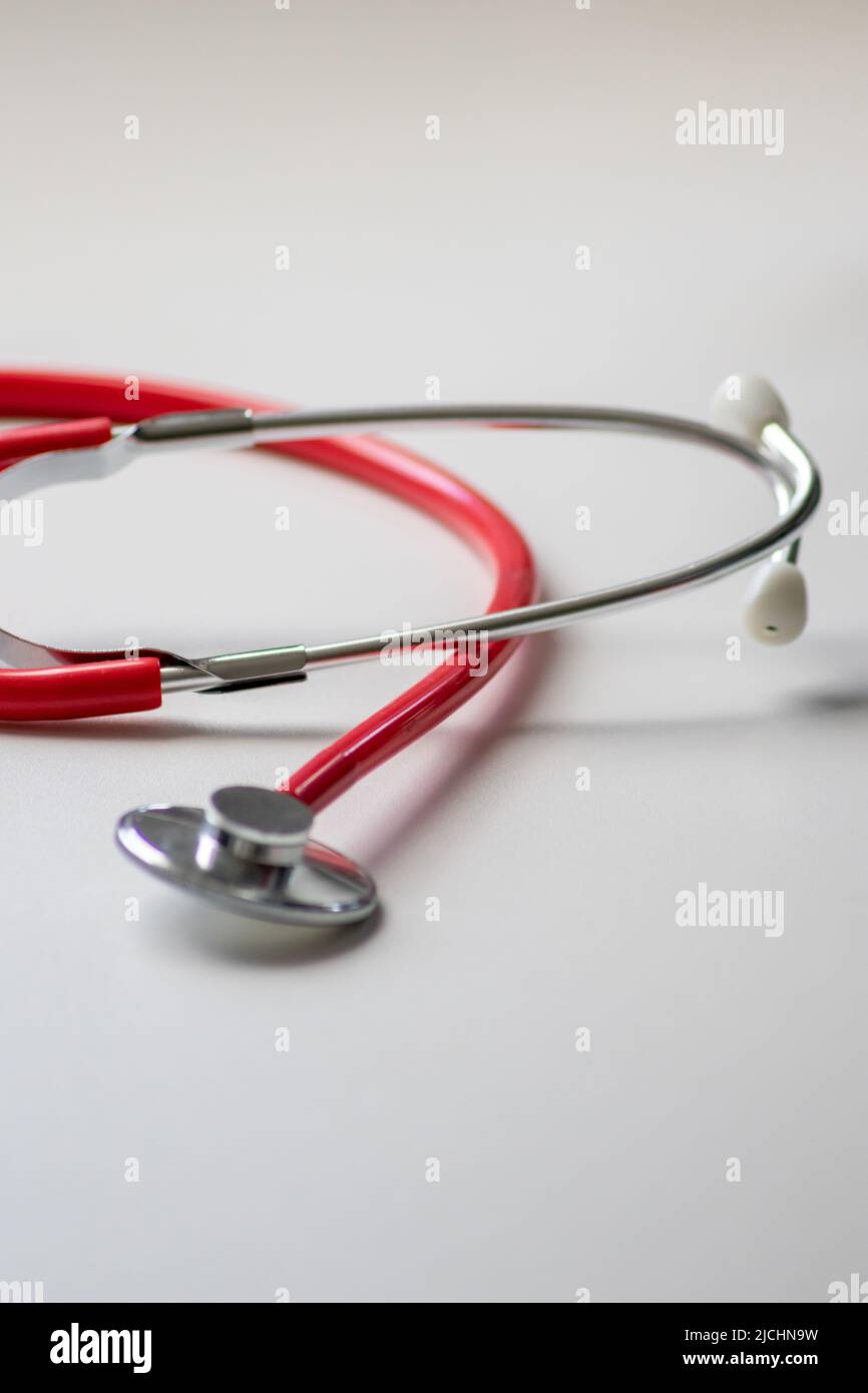 Red stethoscope in doctors office for professional cardio checkup and ...