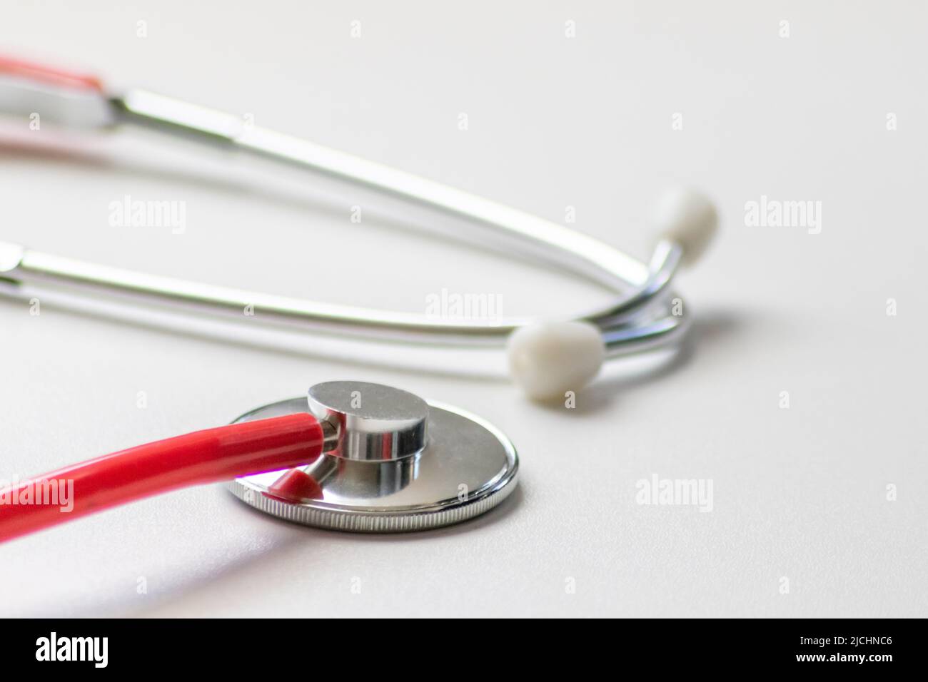 Red stethoscope in doctors office for professional cardio checkup and ...