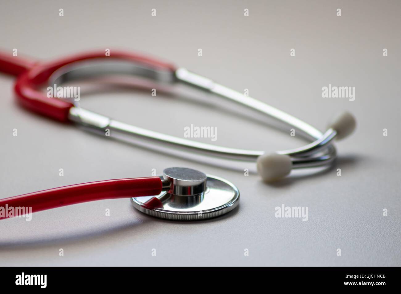 Red stethoscope in doctors office for professional cardio checkup and ...
