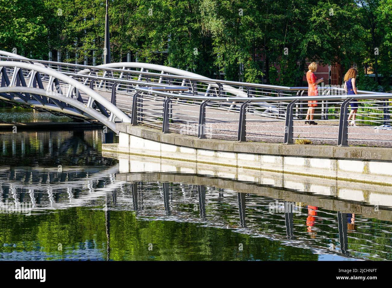 Two women on the Bridge over the lake in Cologne's Mediapark. Cologne ...