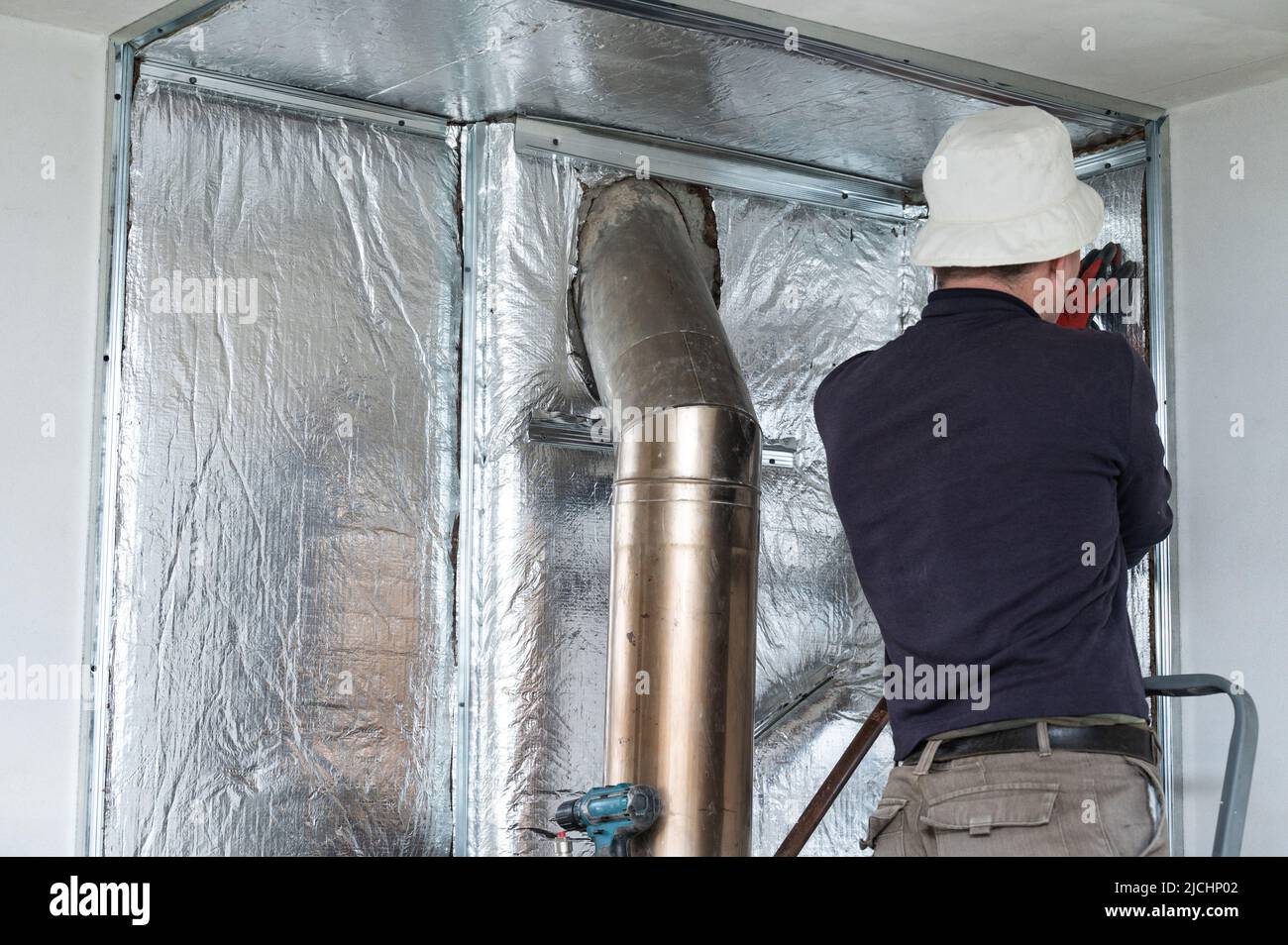 Installation of mineral wool with foil around the fireplace for thermal ...
