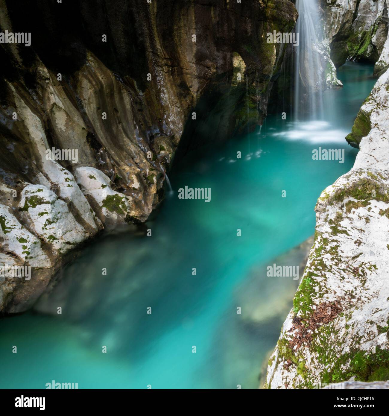 Blurred image of a beautiful waterfall falling in a beautiful emerald ...
